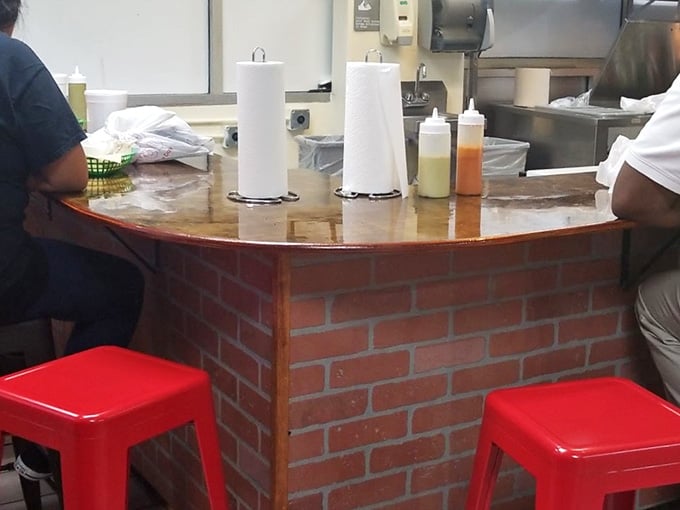 Those bright red stools and brick counter mean business: pull up a seat and prepare for tacos that justify the hype.