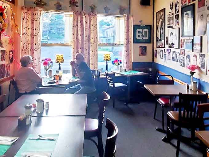 Cozy tables, lace curtains, and walls full of memories create the perfect European dining room atmosphere.