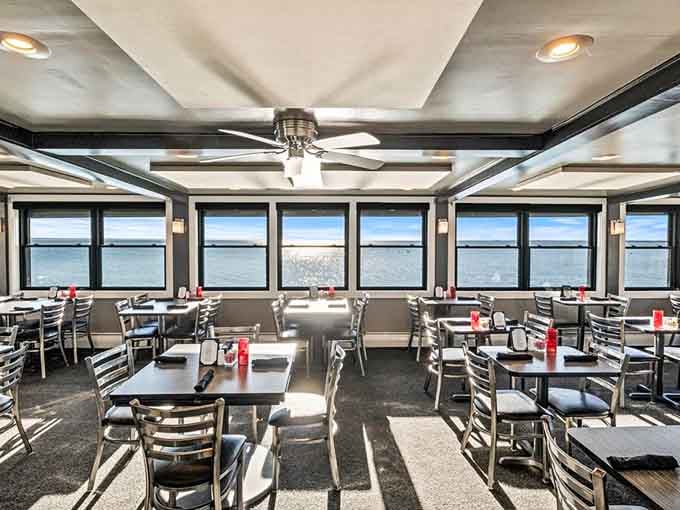 Floor-to-ceiling windows frame the harbor like a living postcard, proving that sometimes the best art is just good real estate.