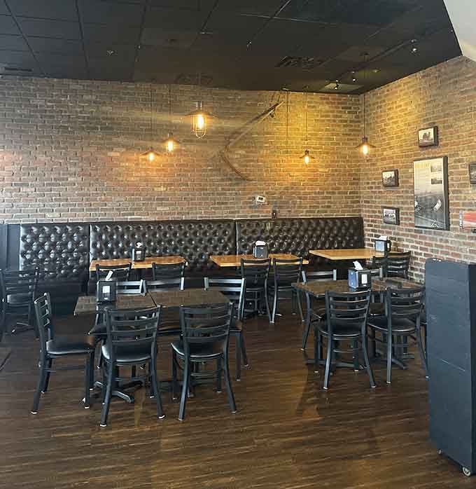 Exposed brick and tufted banquettes prove that great dining spaces can exist anywhere, even next to fuel pumps.