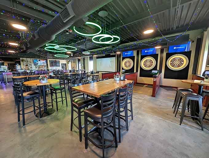 Neon swirls overhead while dartboards beckon; this former control tower now guides you toward good times and great food.