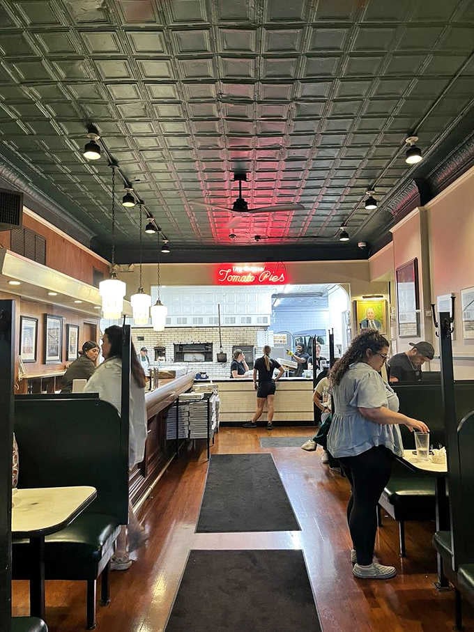 The tin ceiling and vintage booths create an atmosphere that modern restaurants can't buy, only earn through decades of service.