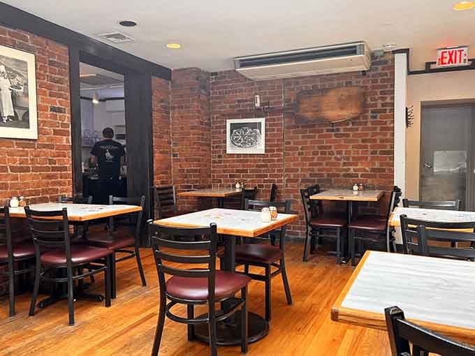 Exposed brick, simple tables, and an atmosphere that says "we've been perfecting this since your grandparents were dating."