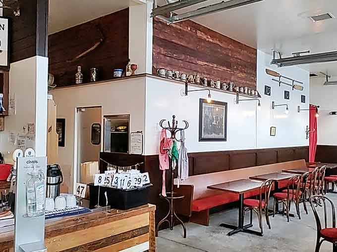 Red banquettes and numbered tables create a welcoming European cafe vibe that invites lingering over coffee.