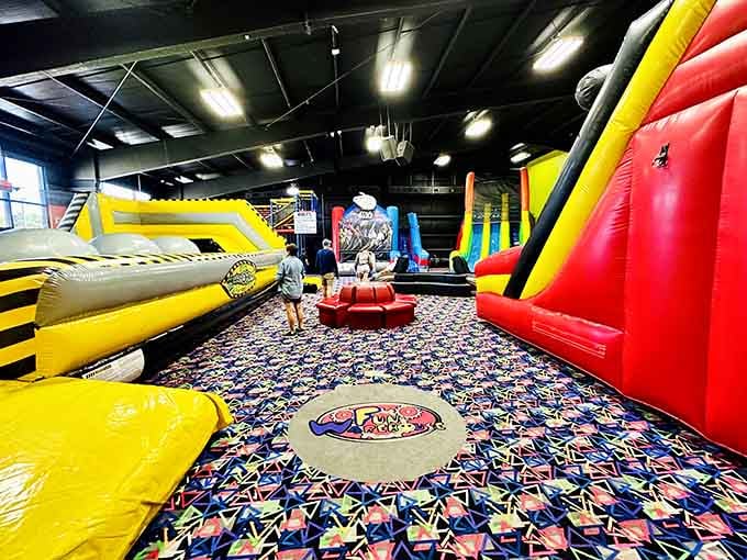 Towering inflatables stretch toward the ceiling like a bouncy castle convention decided to stay permanently.