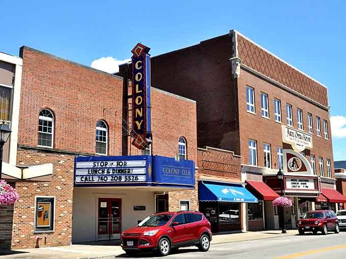 The Colony Theatre's vintage marquee beckons like a portal to simpler times when downtown meant something special.