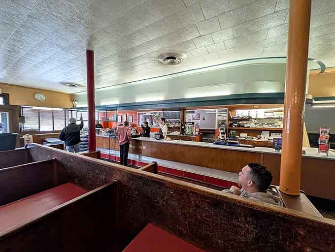 Step inside and you'll find booths that have hosted more conversations than a therapist's couch, all while serving perfect hot dogs.