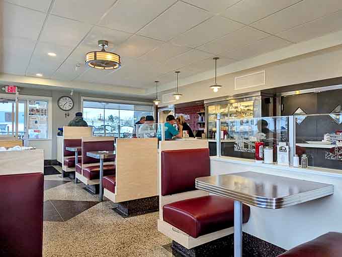 Burgundy booths and chrome accents create the perfect stage for your breakfast performance to unfold beautifully.