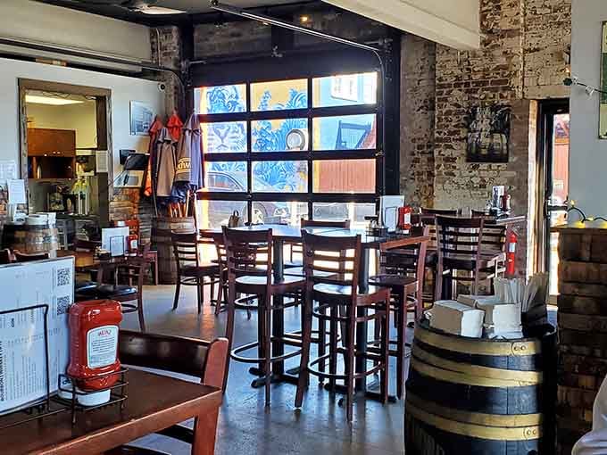 Exposed brick, bourbon barrels as tables, and sunlight streaming through those windows create pure Kentucky magic.