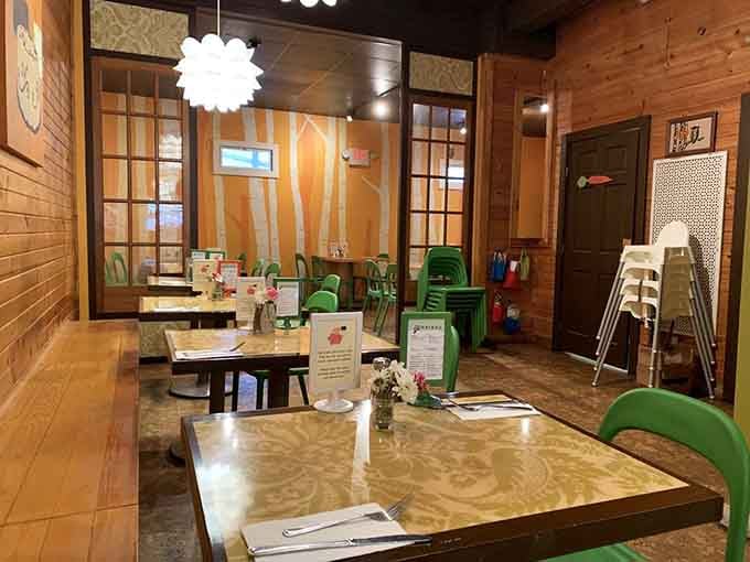 Warm wood tones and those signature green chairs create a vibe that's part coffee shop, part secret clubhouse for grown-ups.