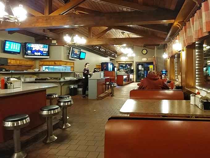 Exposed beams, red booths, and chrome stools create the perfect marriage of lodge charm and classic diner comfort.