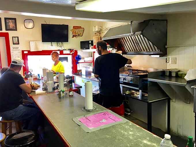 The counter seating puts you front row for the show, where hot dogs become edible art.