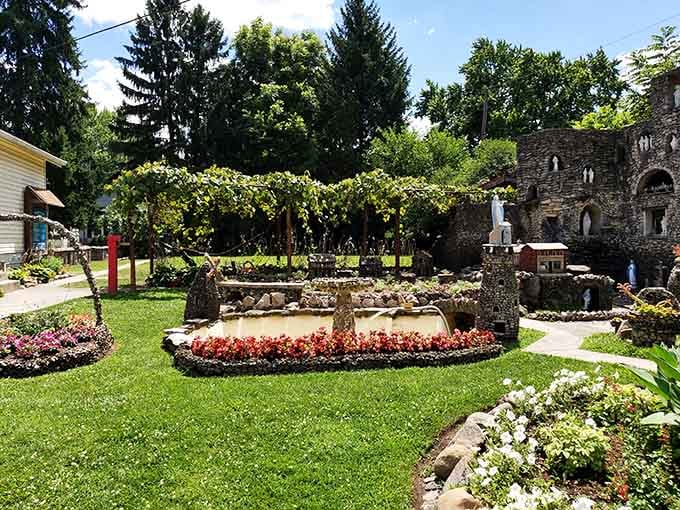 Sunlight dances through the arbor while stone sculptures stand guard, creating a scene straight out of a storybook garden.