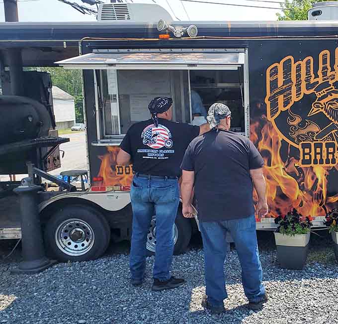 The service window frames a view into smoky heaven where patient pitmasters work their magic daily.
