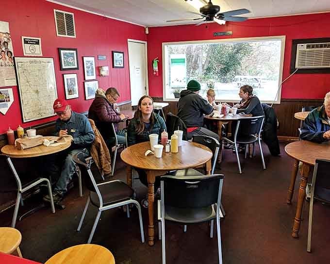 Red walls, mismatched chairs, and people who know exactly what they came for: the perfect no-frills burger sanctuary.