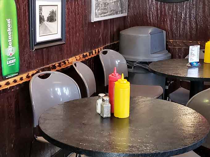Wood-paneled walls and simple round tables create the kind of no-nonsense dining space your grandparents would recognize instantly.