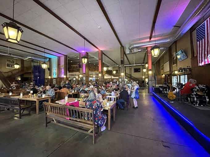 Inside, communal tables stretch like wooden runways to friendship, laughter, and possibly questionable decisions.