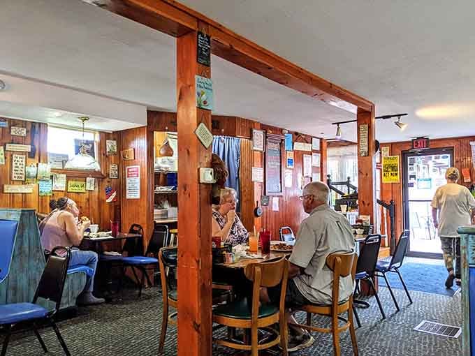 Wood paneling and cozy tables create the kind of atmosphere where strangers become friends over coffee refills.