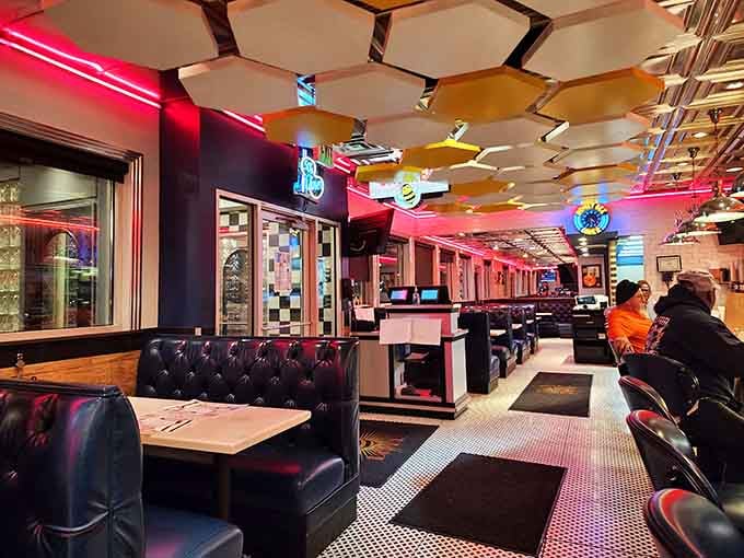 Pink neon and checkered floors create a retro wonderland where every booth feels like a time machine.