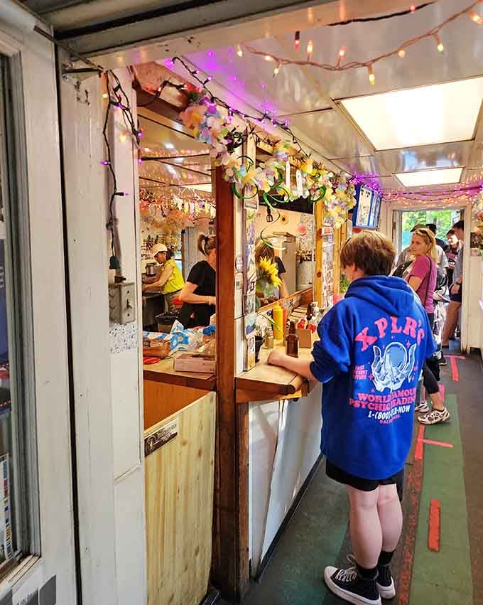String lights and smiles create the perfect atmosphere for ordering your next favorite meal through that window.