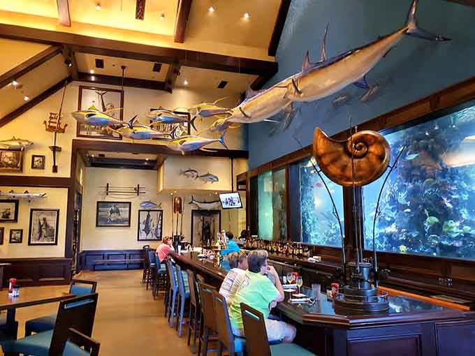 That bar setup with live fish swimming behind it beats staring at bottles any day of the week.