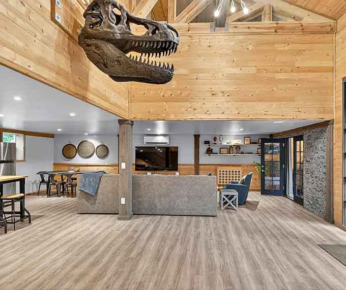 A T-Rex skull suspended from cathedral ceilings proves someone understood the assignment and then exceeded all expectations beautifully.