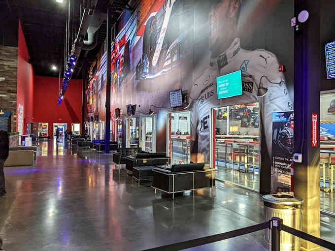 This lobby doesn't whisper "fun ahead." It shouts it from massive racing murals covering every wall.