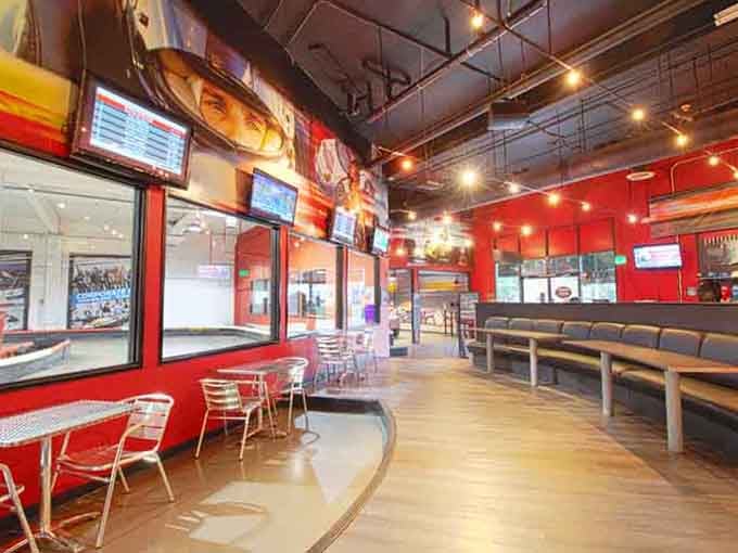 Modern comfort meets motorsport energy in this sleek lounge where racers refuel and relive their greatest track moments.