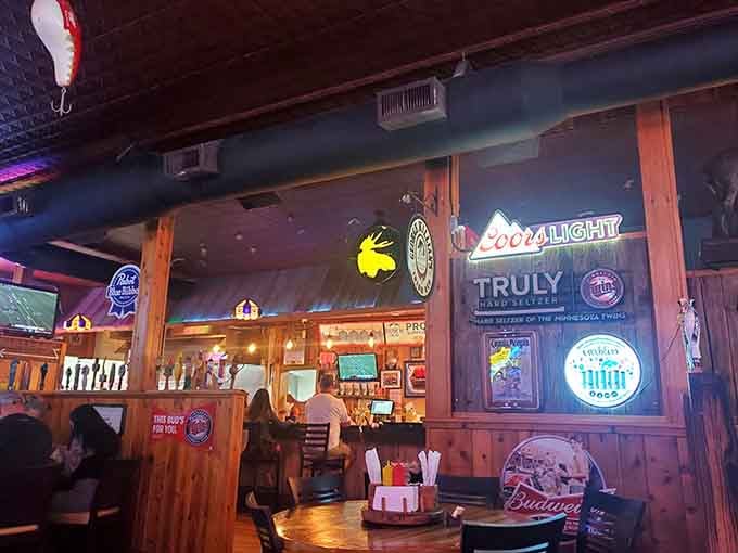 Beer signs and neon glow create the kind of atmosphere where strangers become friends over shared baskets of fries.