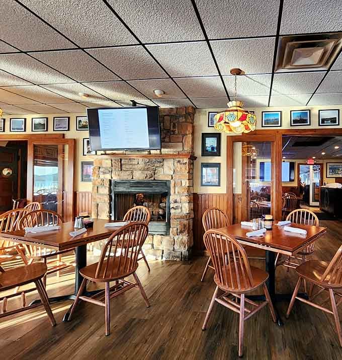Wood tones, maritime charm, and a stone fireplace create the kind of cozy atmosphere where memories are made over perfectly prepared seafood.