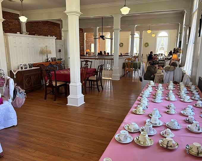 Those mismatched vintage teacups lined up like a porcelain rainbow are just the beginning of the magic.