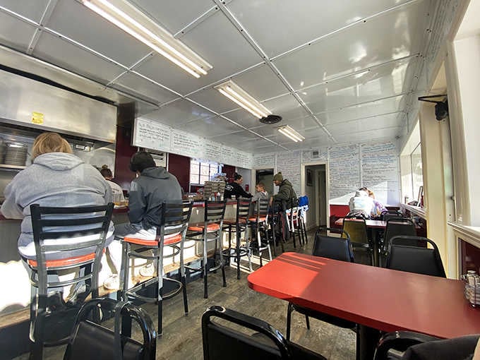Inside, red tables and counter seating create the perfect backdrop for serious comfort food conversations.