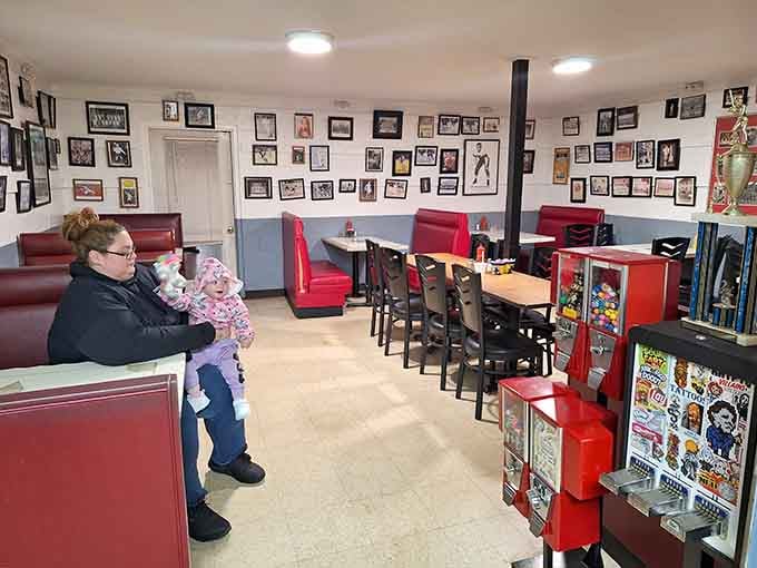 Red booths, vintage gumball machines, and walls full of memories create the perfect nostalgic dining atmosphere.