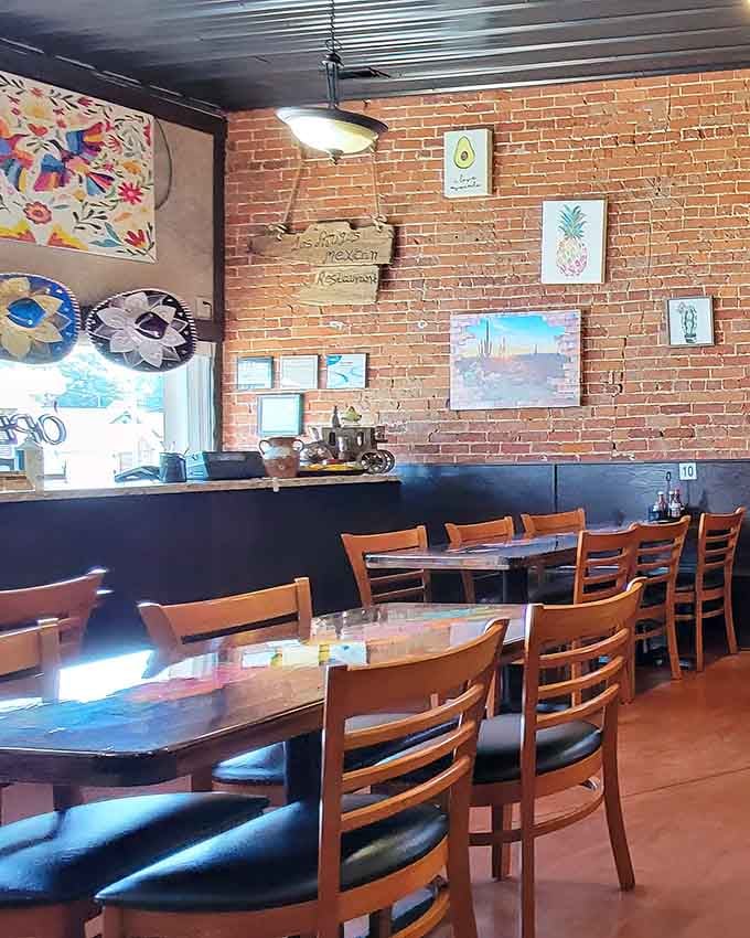 Exposed brick meets colorful art in a space that feels both rustic and welcoming, like your coolest friend's dining room.