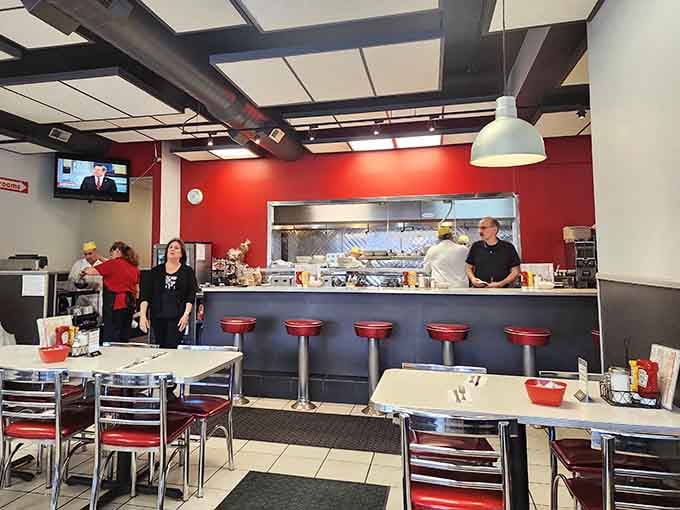 Red walls, chrome stools, and an open kitchen where breakfast magic happens right before your hungry eyes.