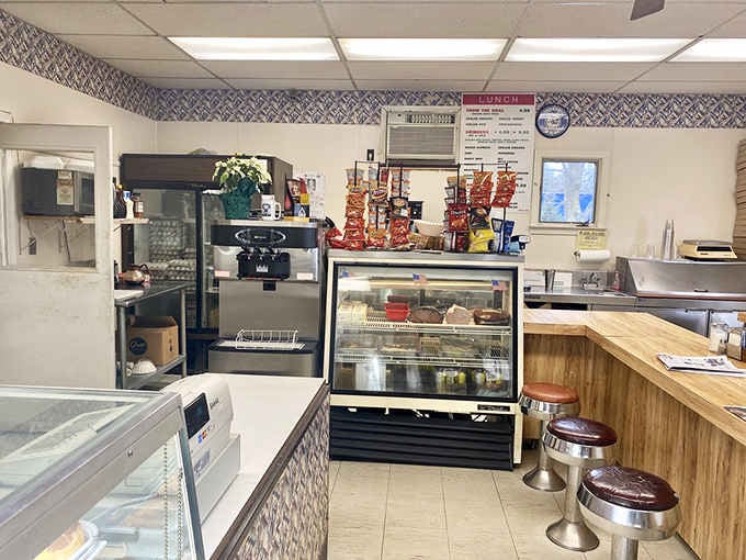 Classic counter seating where locals gather for morning rituals, proving the best conversations happen over coffee and fresh-baked goods.