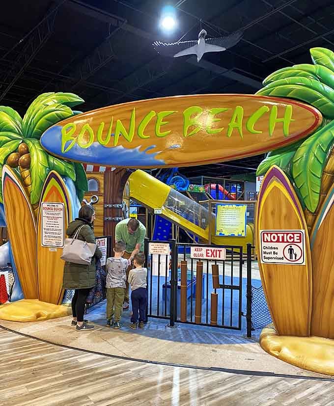 The Bounce Beach entrance looks like a tropical vacation decided to set up shop in Kentucky, complete with surfboards and palm trees.
