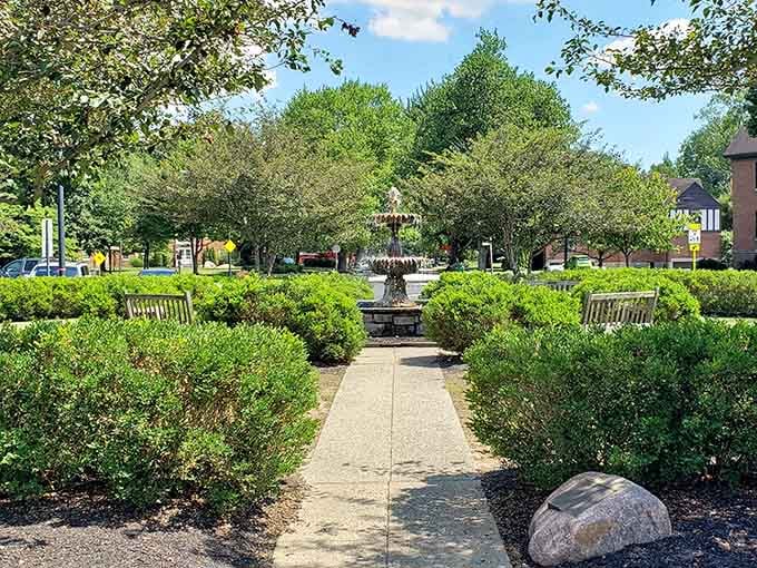 This fountain-centered garden proves that even hedges deserve a proper gathering spot for neighborhood gossip and contemplation.