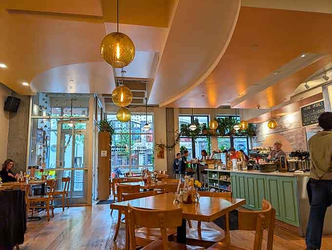 Natural light floods through those gorgeous windows while pendant lights add warmth to a space that feels both contemporary and inviting.