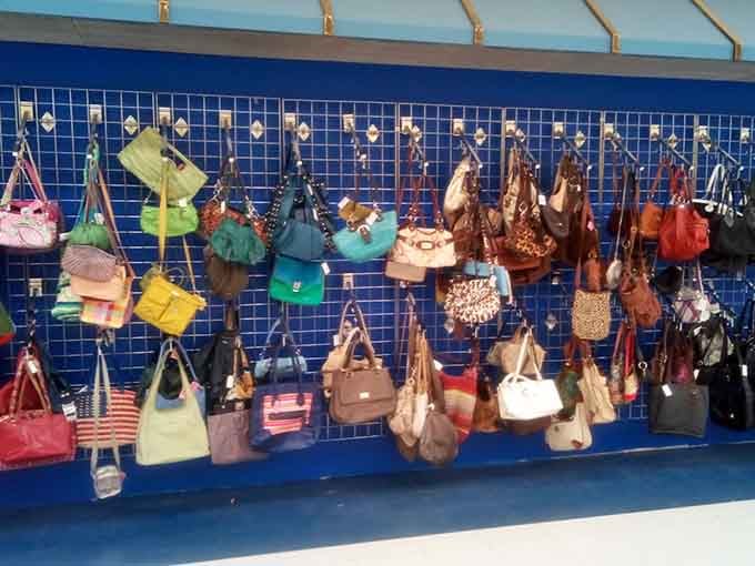 A rainbow of handbags waiting for their next adventure, because everyone deserves affordable style without the guilt.