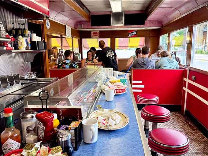 Elbow-to-elbow counter seating where strangers become friends over coffee refills and shared hot sauce bottles.