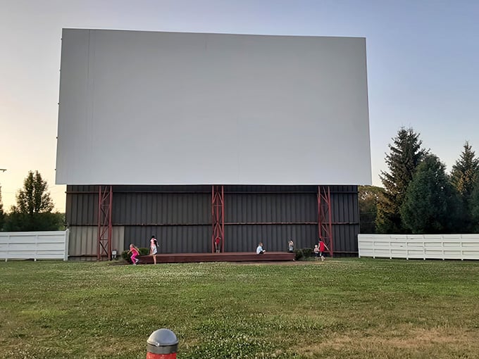 Kids playing on the grass before showtime, because the best theaters come with built-in entertainment zones.