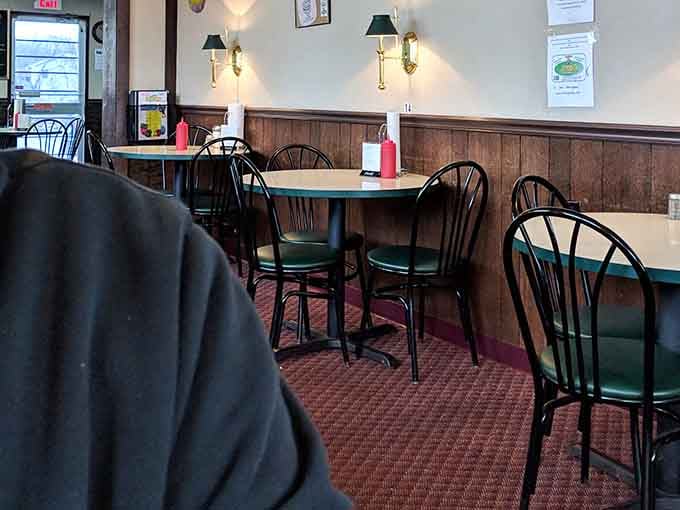 Classic booth seating and wood paneling create the perfect backdrop for conversations that linger long after the plates are cleared.