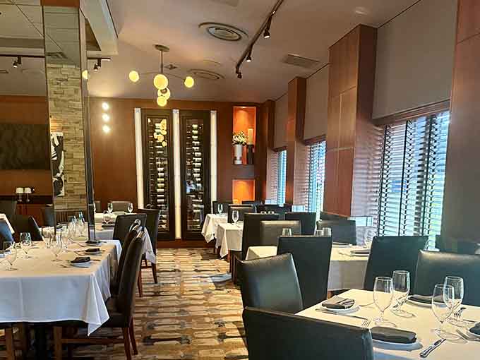 White tablecloths and wine towers create an atmosphere where even your casual Tuesday feels like a scene from a Cary Grant movie.