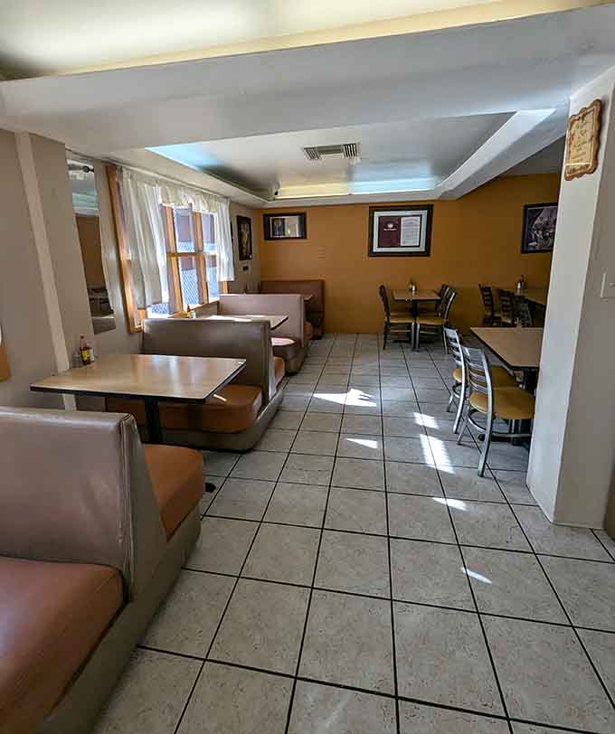 Simple booths, warm lighting, and walls full of memories make this dining room feel like coming home.