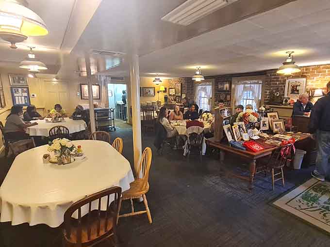 Round tables dressed in white linens await the daily gathering where strangers become dining companions over Southern comfort.