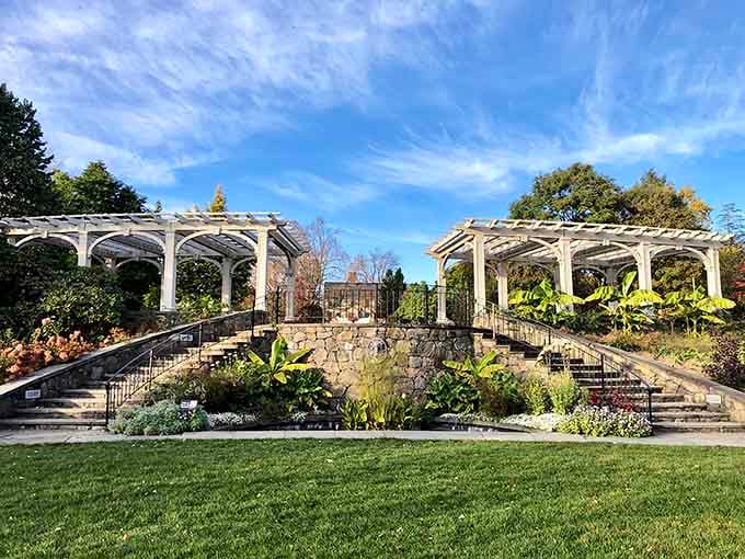 Twin pergolas frame this formal garden space where symmetry meets spectacular views of the surrounding landscape.