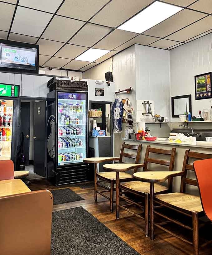 Simple wooden tables and orange chairs prove you don't need fancy decor when your food does all the talking.