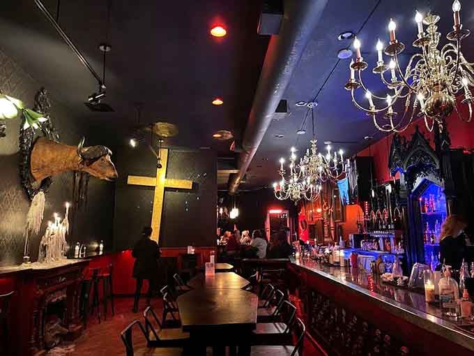 Crystal chandeliers and taxidermy create an atmosphere that's equal parts elegant ballroom and haunted mansion vibes.