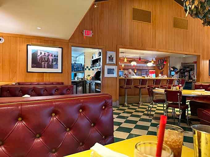 Checkered floors and burgundy booths create the kind of atmosphere where time slows down deliciously.
